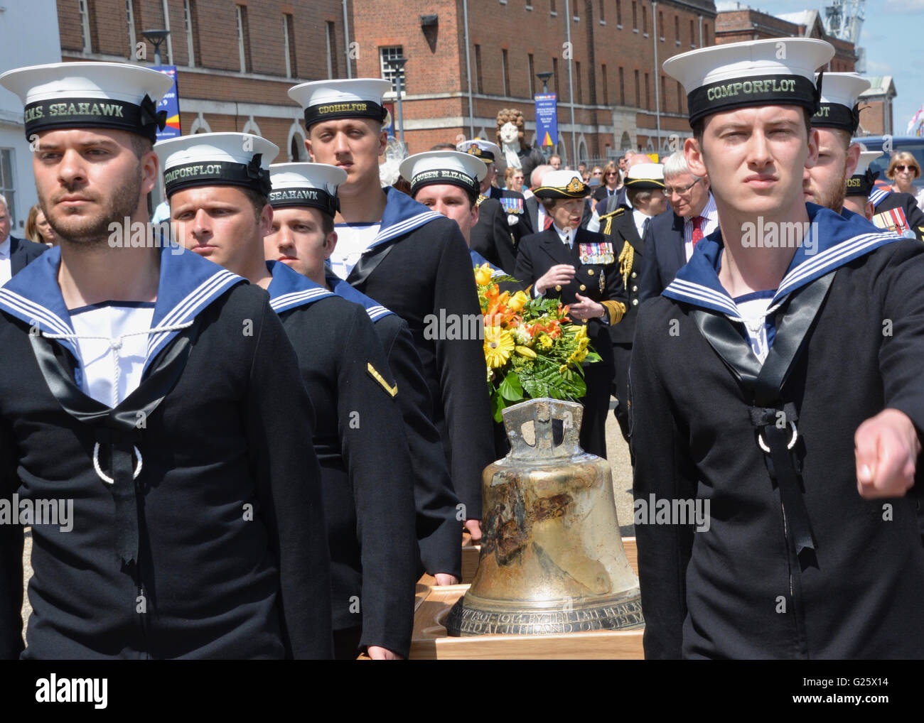 The bell from HMS Hood is carried by a Royal Navy guard followed by the ...