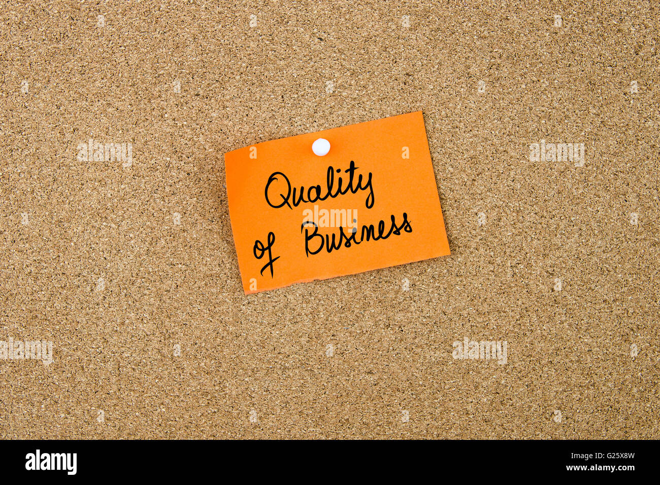 QUALITY of BUSINESS written on orange paper note pinned on cork board ...