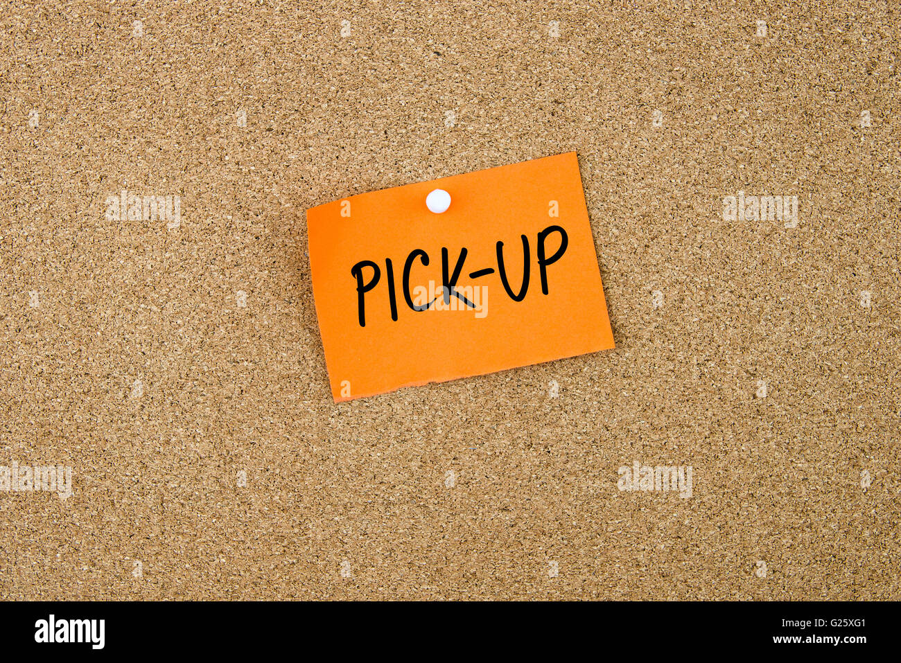 Pick-Up written on orange paper note pinned on cork board with white ...