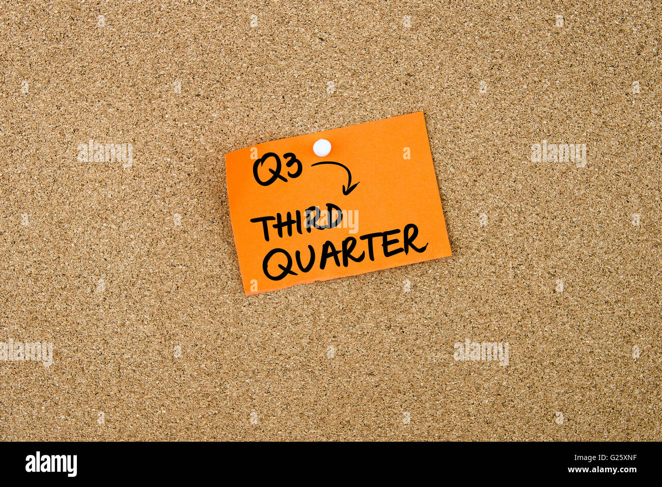 Q3 THIRD QUARTER written on orange paper note pinned on cork board with ...