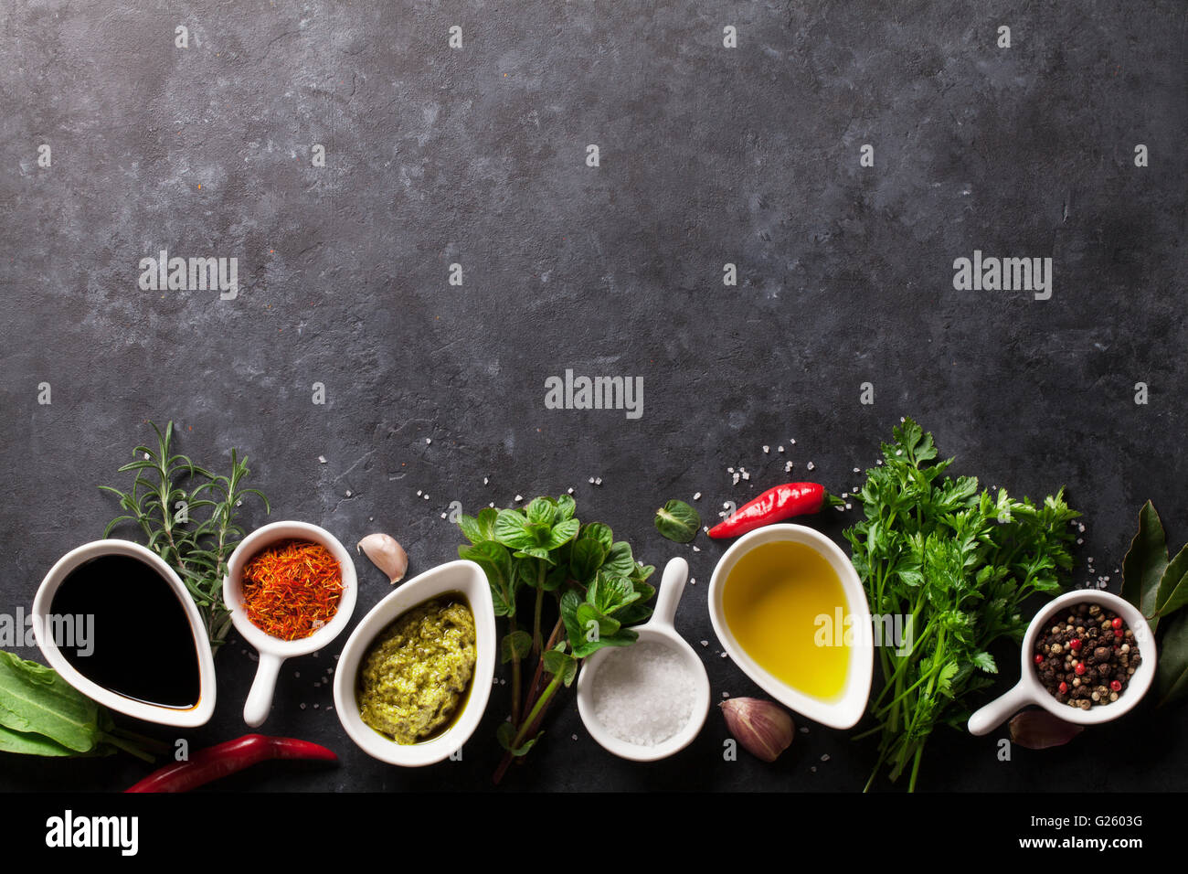 Herbs, condiments and spices on stone background. Top view with copy ...