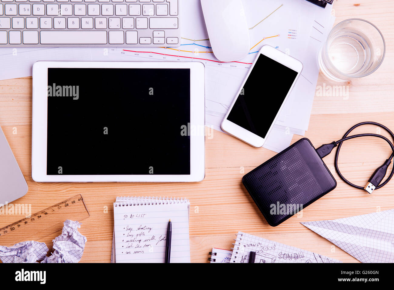 Gadgets and office supplies, chart graph. Wooden background Stock Photo ...