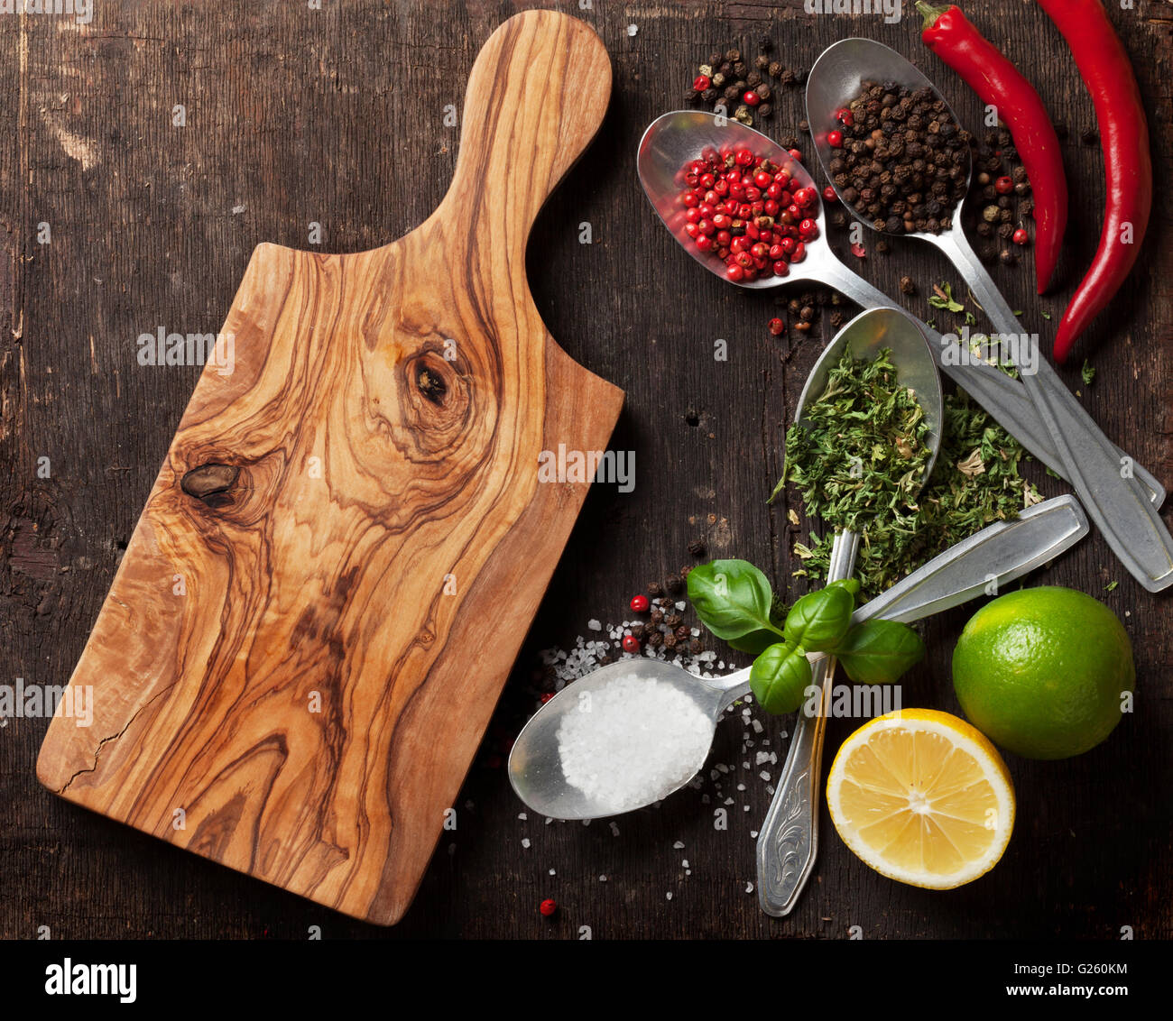 Herbs and spices and cutting board on wooden table. Top view with copy ...