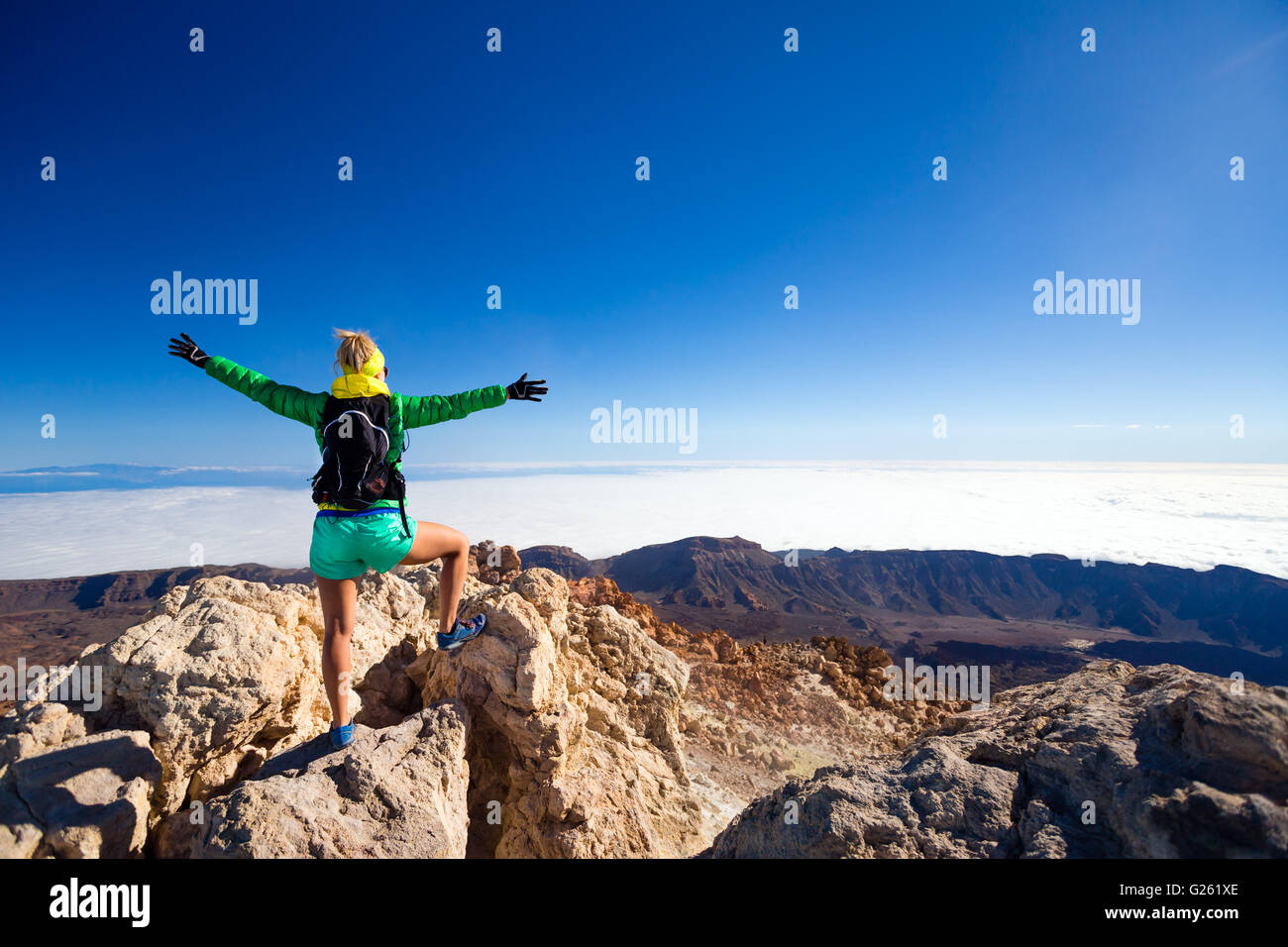 Female mountain hiker reaching peak hi-res stock photography and images ...