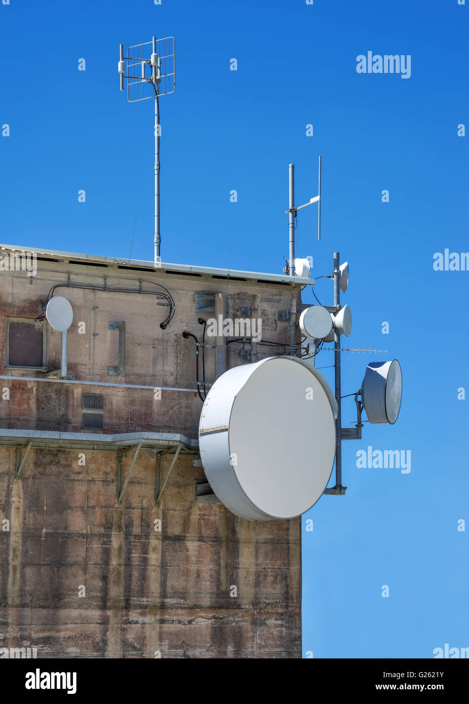 Modern antennas on an old industrial building Stock Photo - Alamy