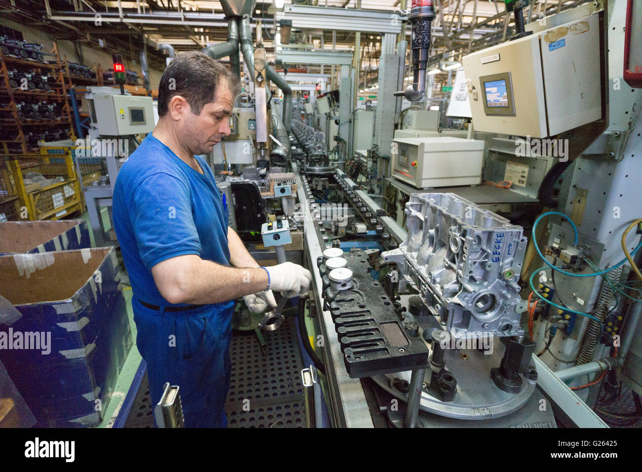 Tehran, Iran. 14th May, 2016. A worker places a piston in an engine ...