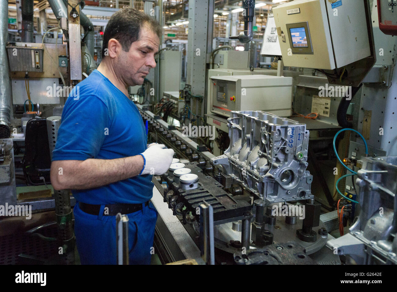 Tehran, Iran. 14th May, 2016. A worker places a piston in an engine ...
