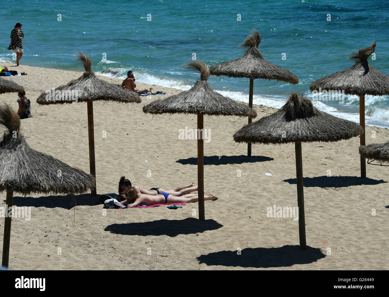 The Es Portixol beach with sunshades made of reed and few beach ...