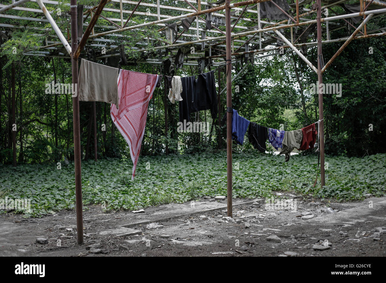 Clothes left to dry inside an abandoned building used by refugees and ...