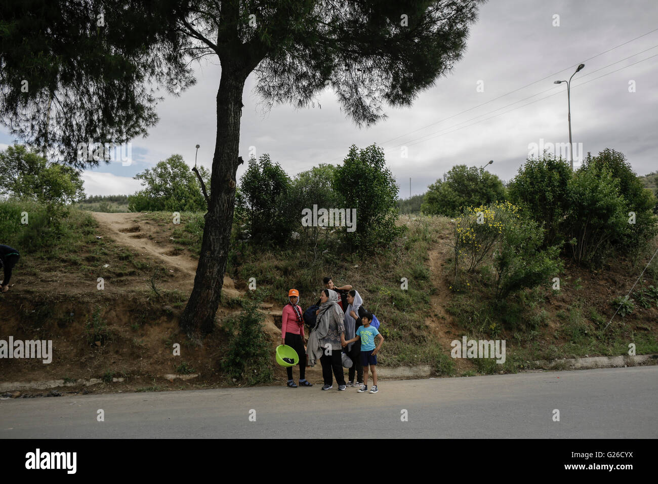 Refugees and migrants near a temporary camp outside Idomeni village in ...