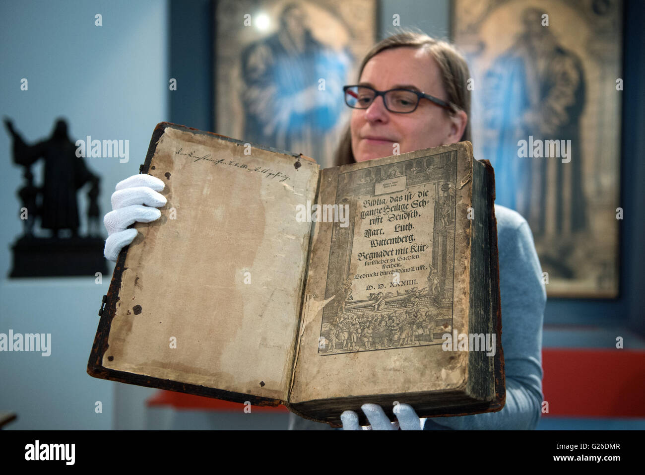 Friederike Lippold holds up a a volume of the first complete complete ...