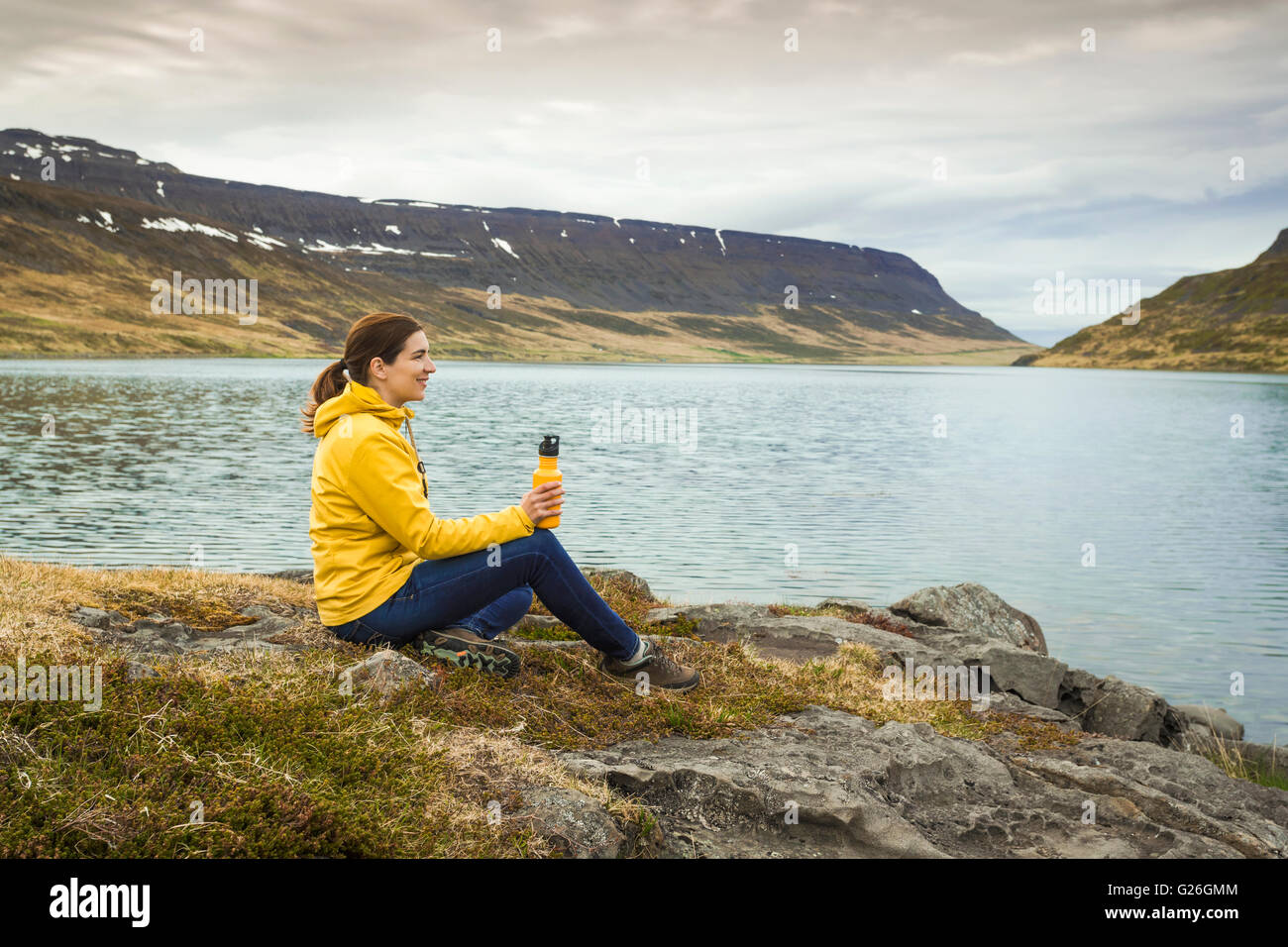 Beautiful woman resting close to a beautiful lake Stock Photo - Alamy