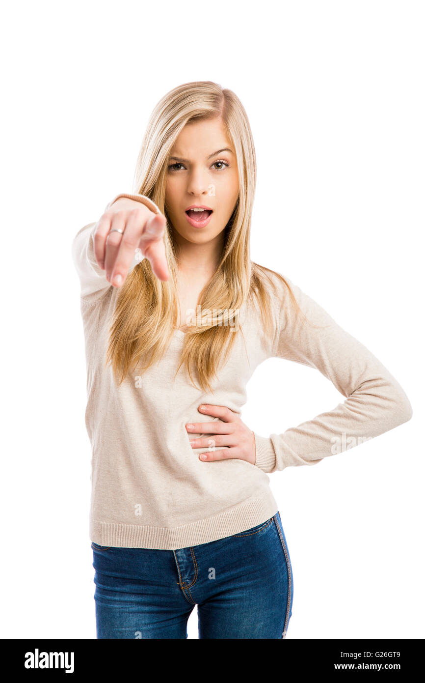 Beautiful and happy teenage girl pointing, isolated over white ...