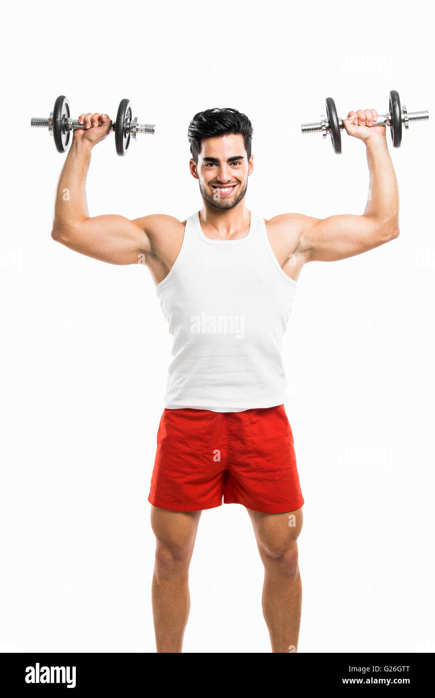 Portrait of handsome young man lifting weights, isolated on white ...