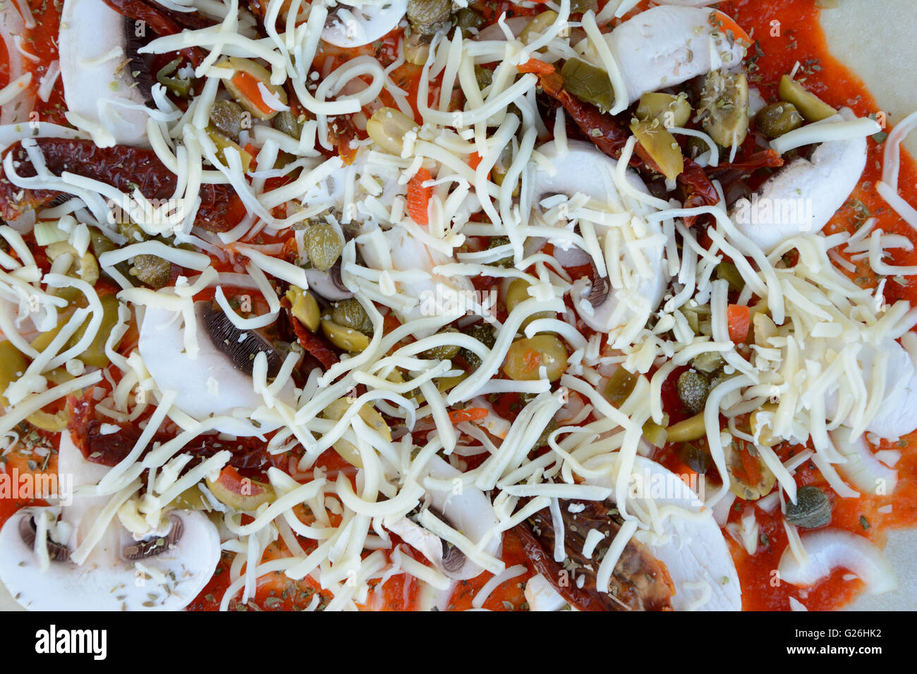 Raw pizza before baking - close up Stock Photo - Alamy