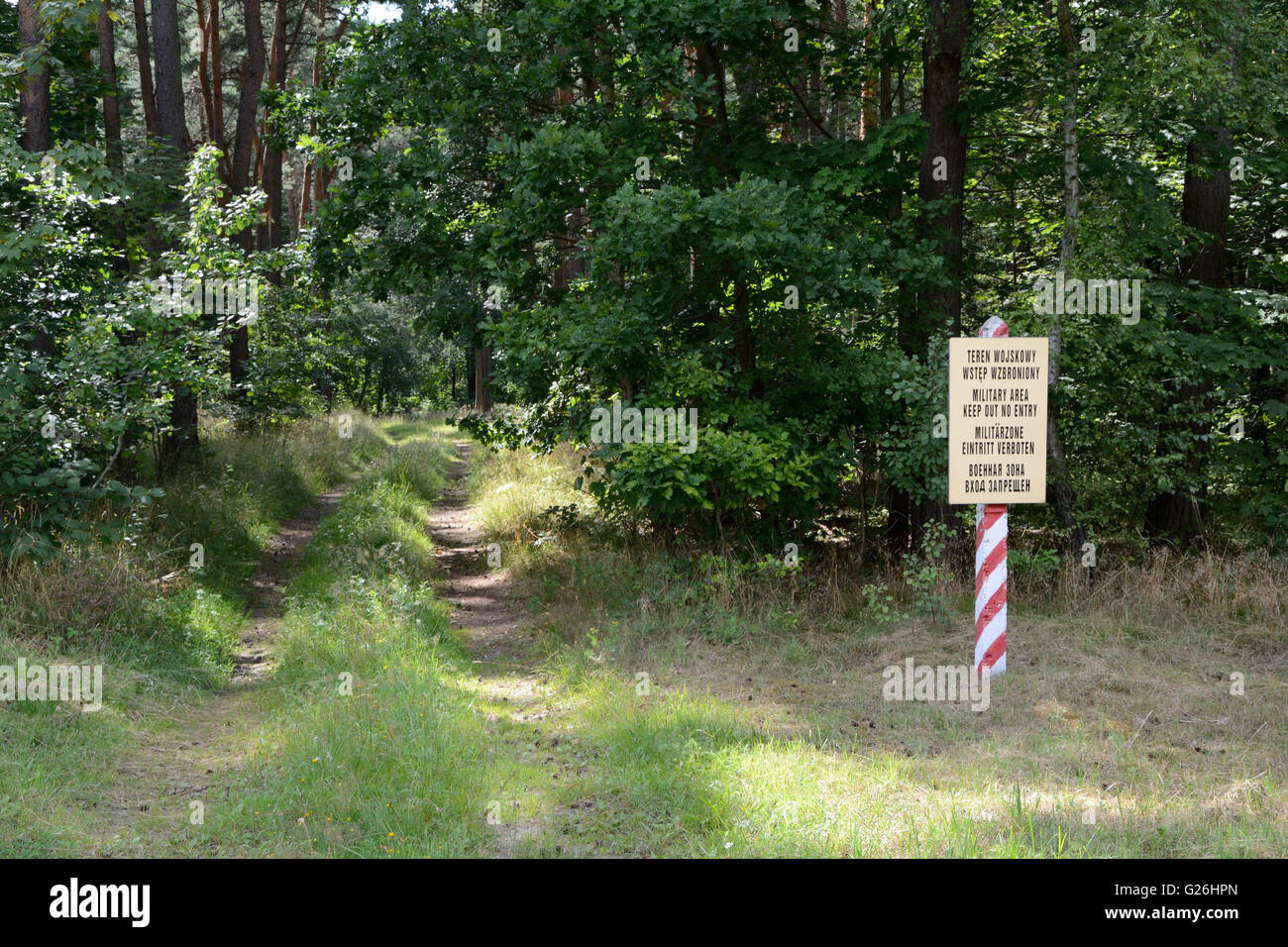 Military area keep out no entry sign in four languages: polish, english ...