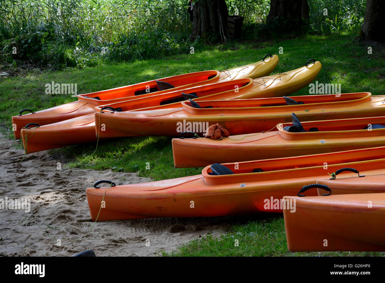 Several kayaks on lake shore Stock Photo - Alamy