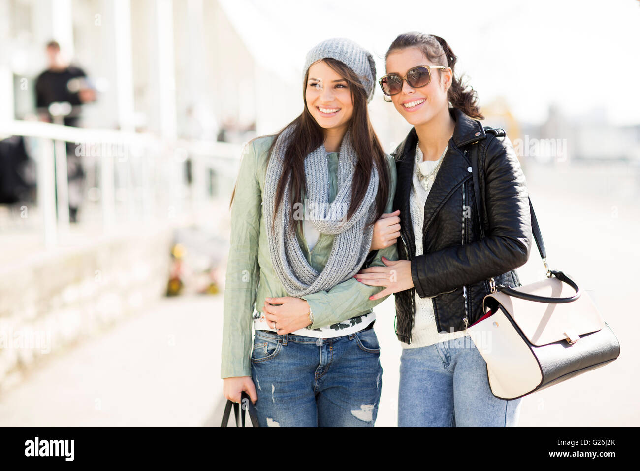 Two women walking together on the street Stock Photo - Alamy