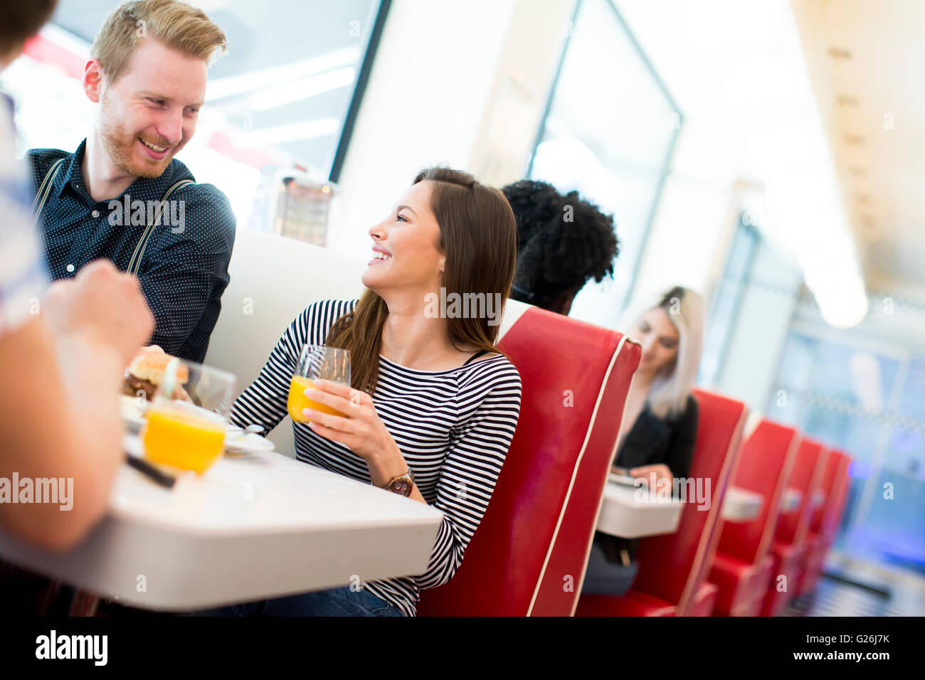 Friends eating at the table in the diner Stock Photo - Alamy
