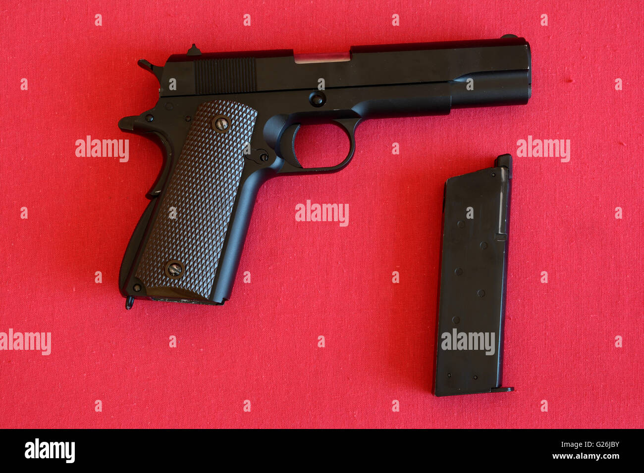 Airsoft gun and magazine on red fabric Stock Photo - Alamy