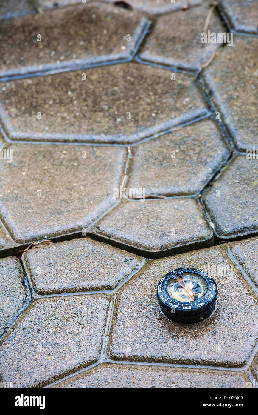 compass on paving stones in rain Stock Photo - Alamy