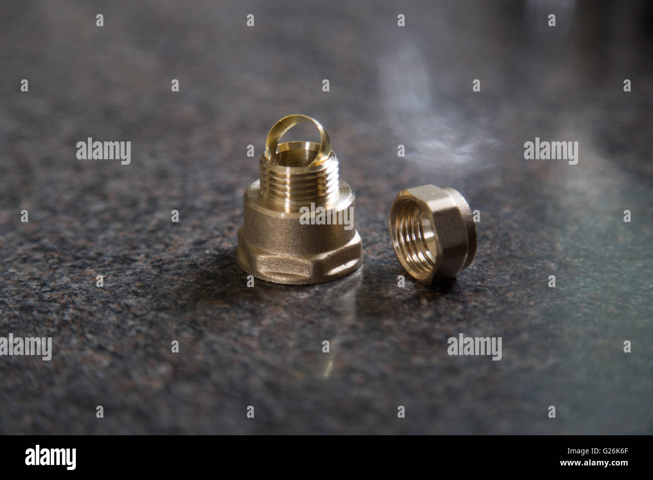 A brass plumbing fitting showing the nut and olive Stock Photo - Alamy