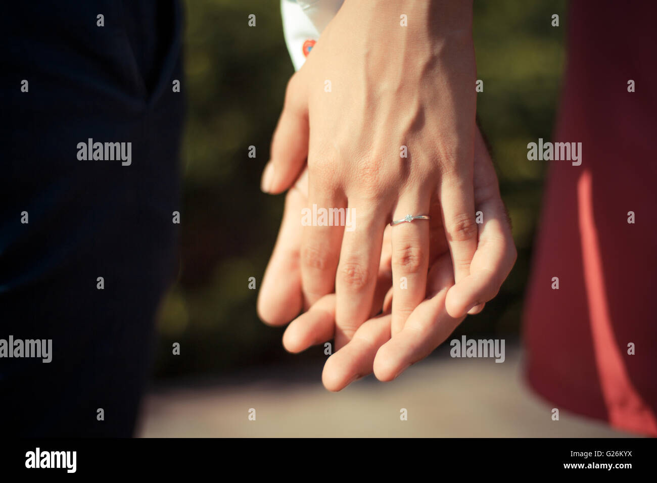 Wedding couple holding hands on sunset background Stock Photo - Alamy