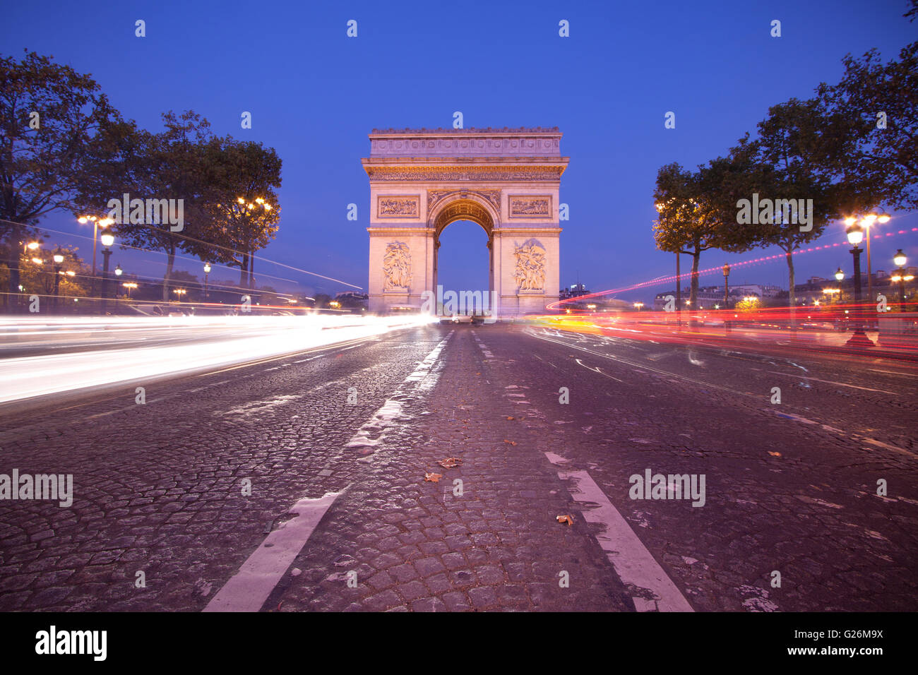 Front view of Arc de Triomphe (Arch of Triumph) in Paris at dusk with ...
