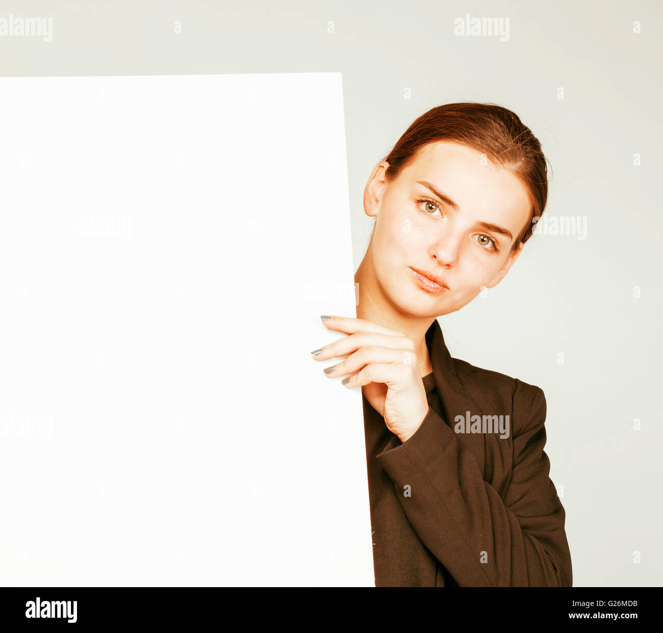 young pretty brunette girl with placard on white background wearing ...