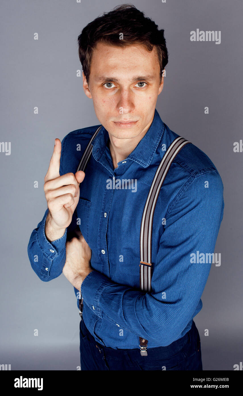 young goofy man with pimples pointing in studio Stock Photo - Alamy