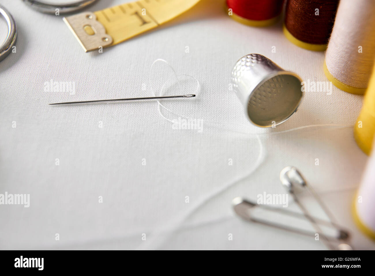 Sewing tools on white fabric background. Horizontal composition ...