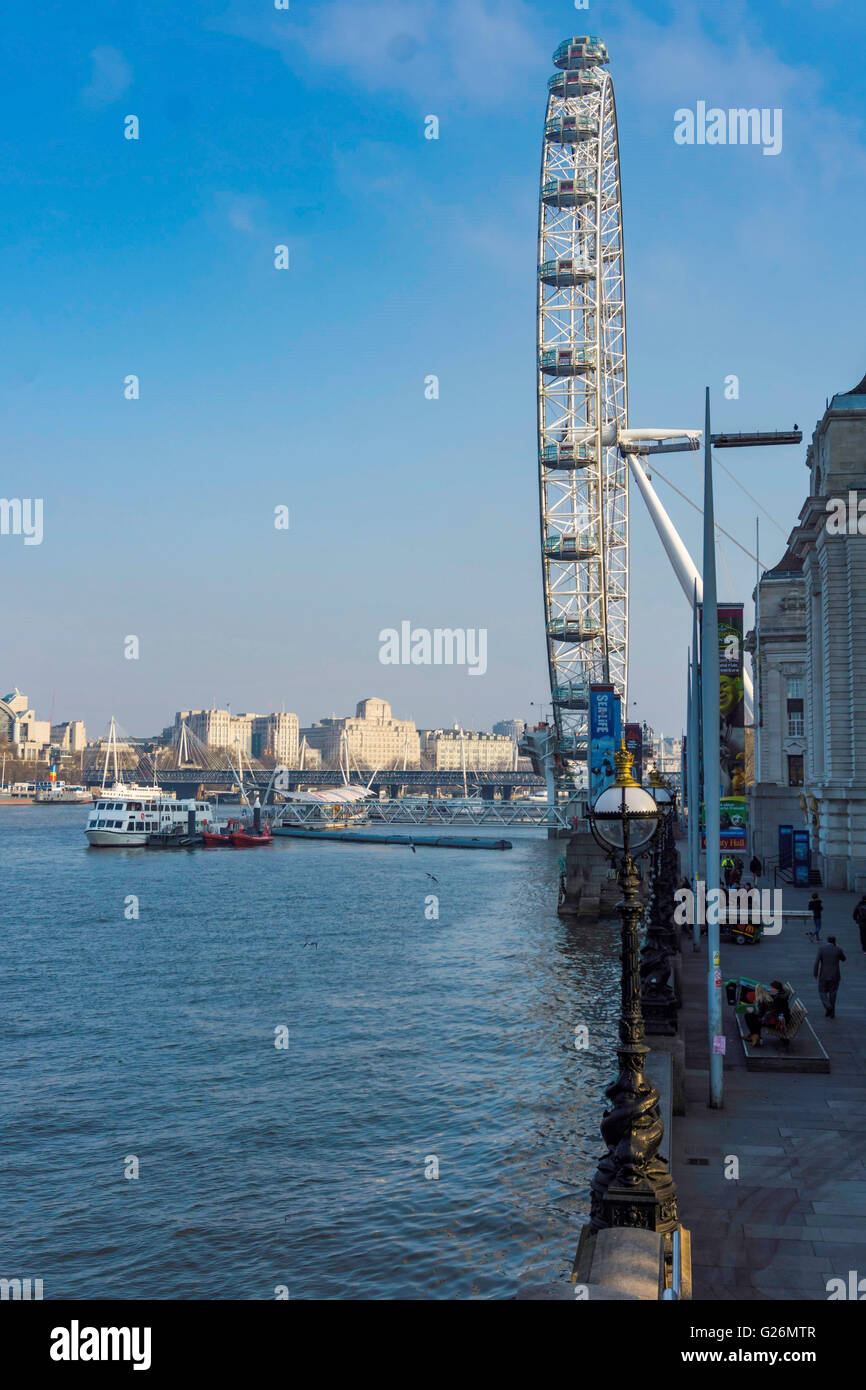 London Eye from Westminster Bridge at high tide on the Thames Stock ...