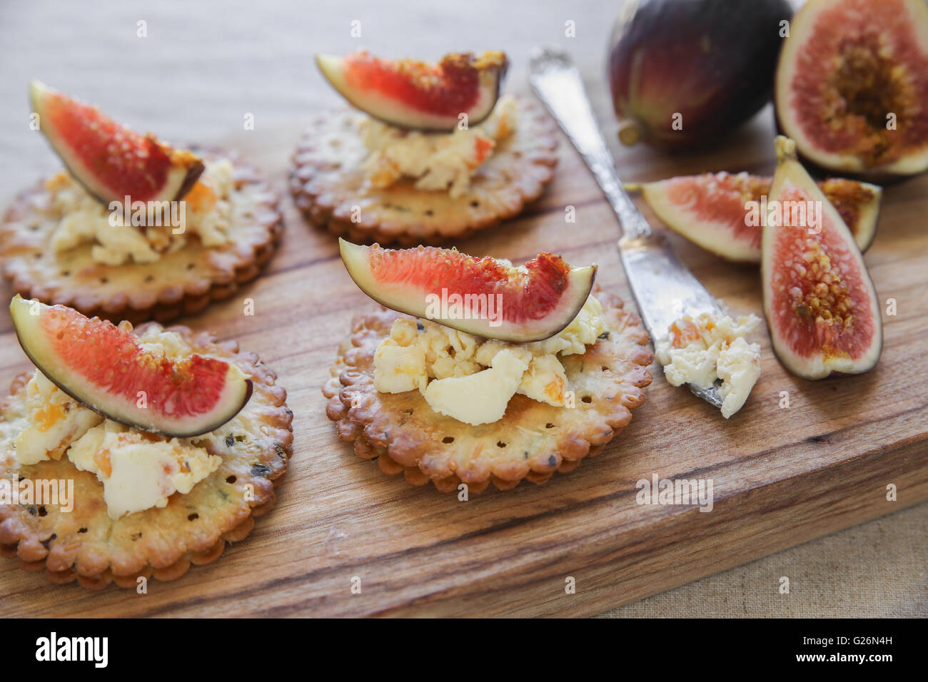 Cracker canapes with fresh fig and cream cheese, selective focus Stock ...