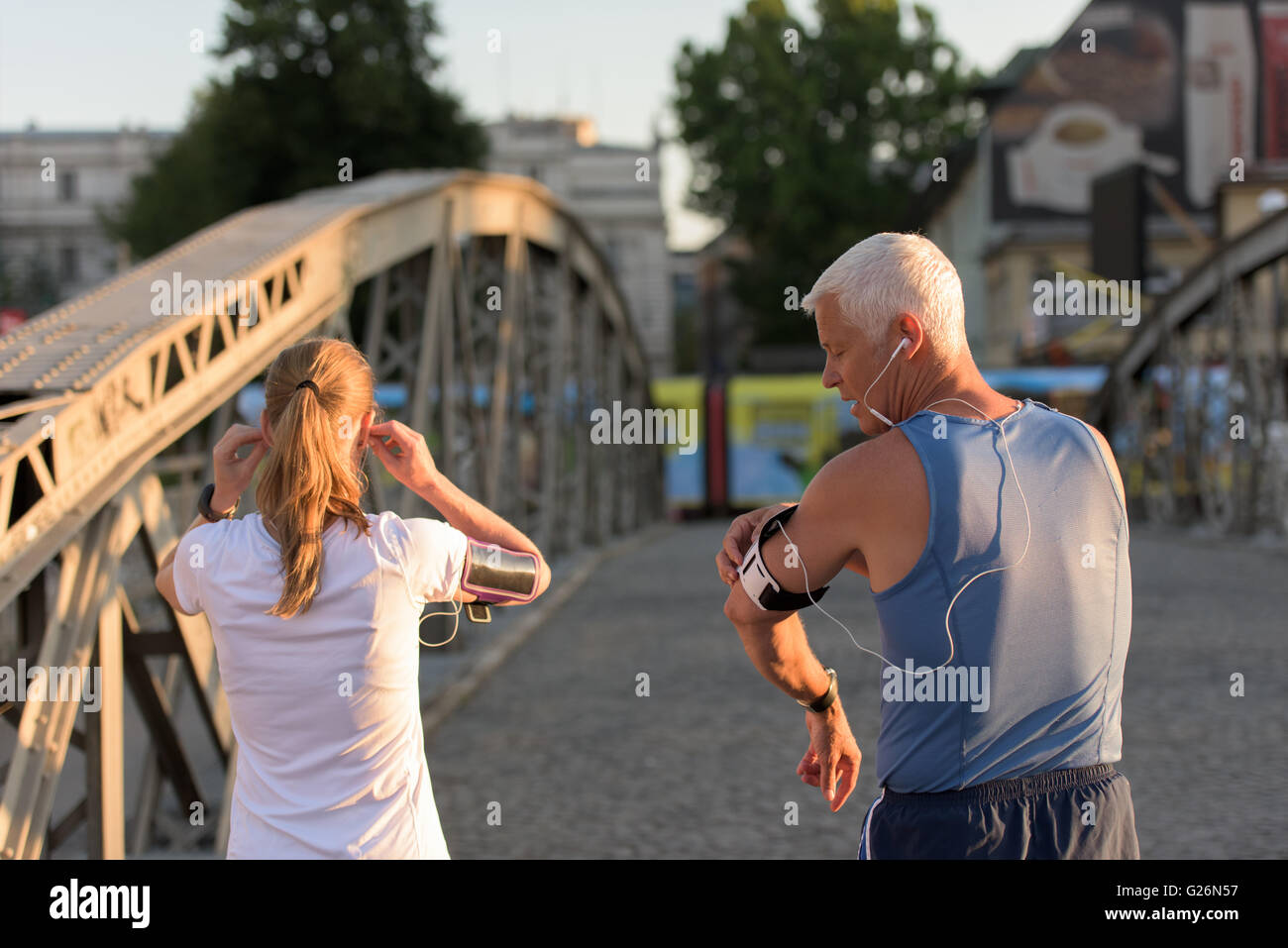 jogging couple check music playlist on phone and plan route before ...