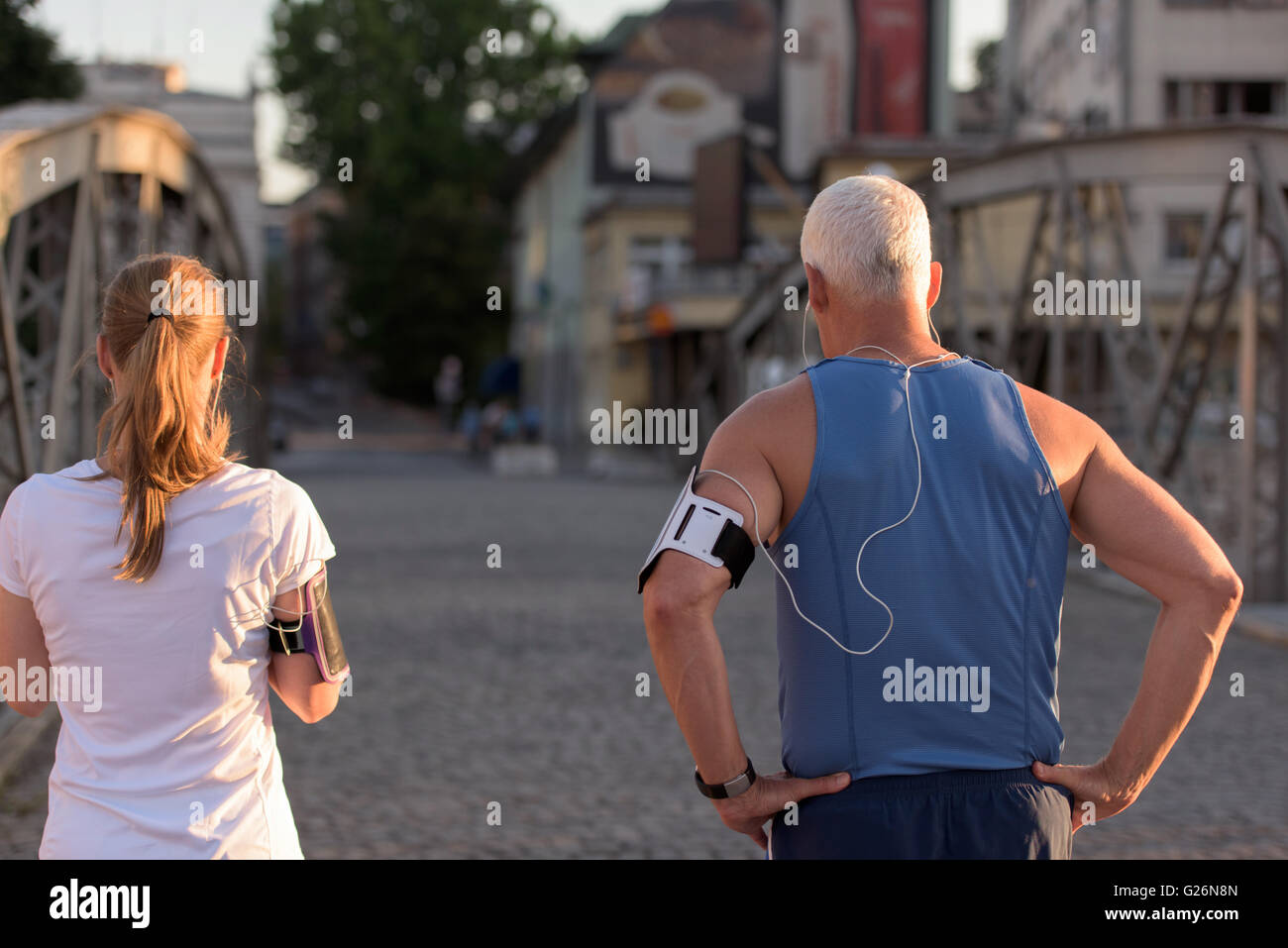 jogging couple check music playlist on phone and plan route before ...