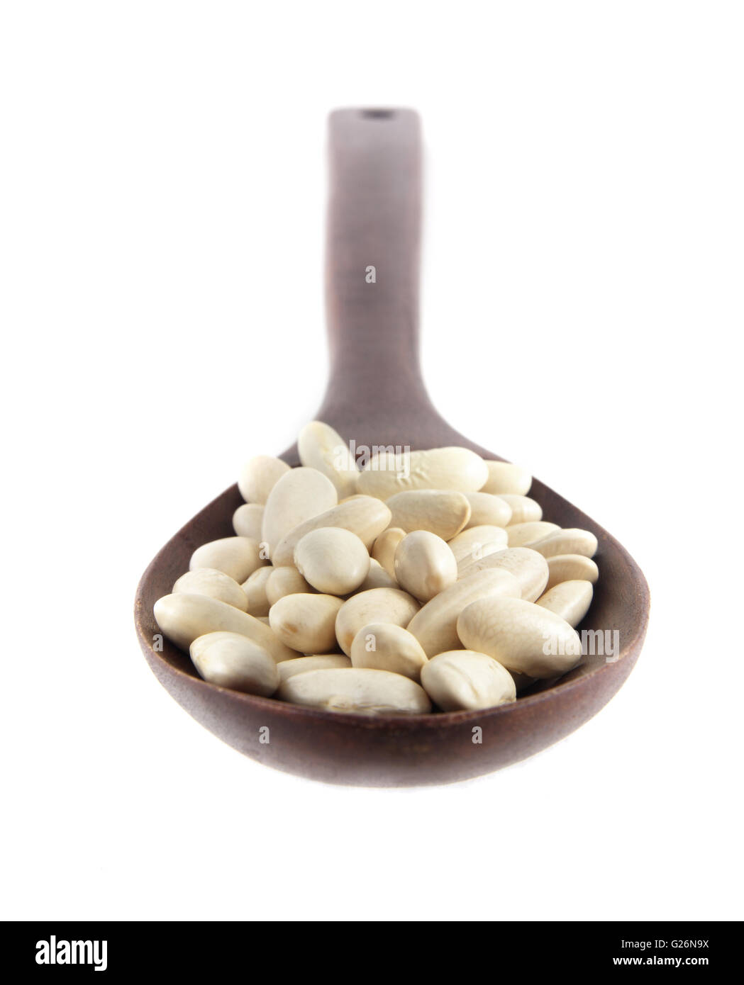 White beans on a wooden spoon isolated on white background - Shallow ...