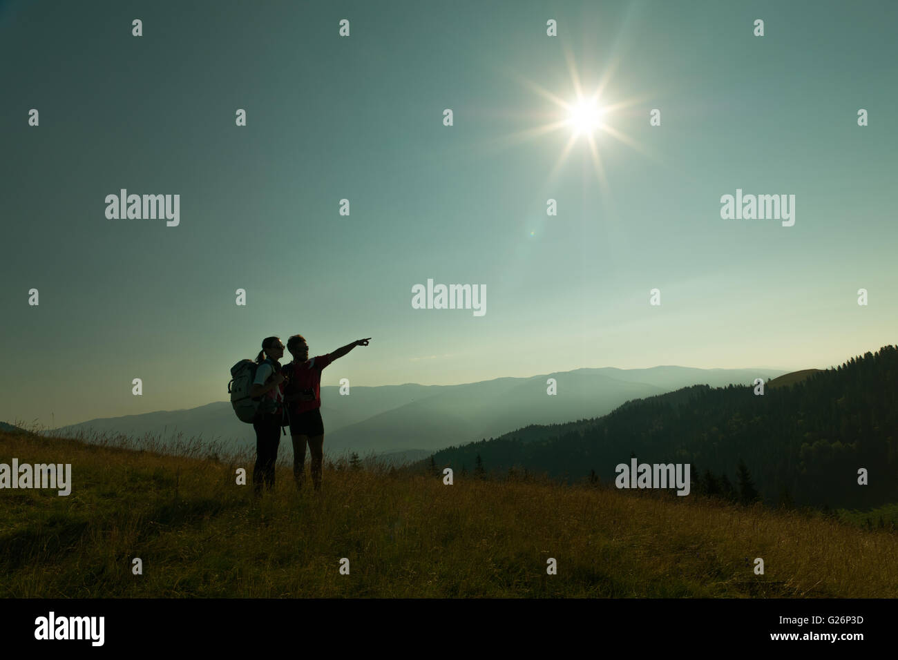 two people hiking on the mountain in a peaceful afternoon Stock Photo ...
