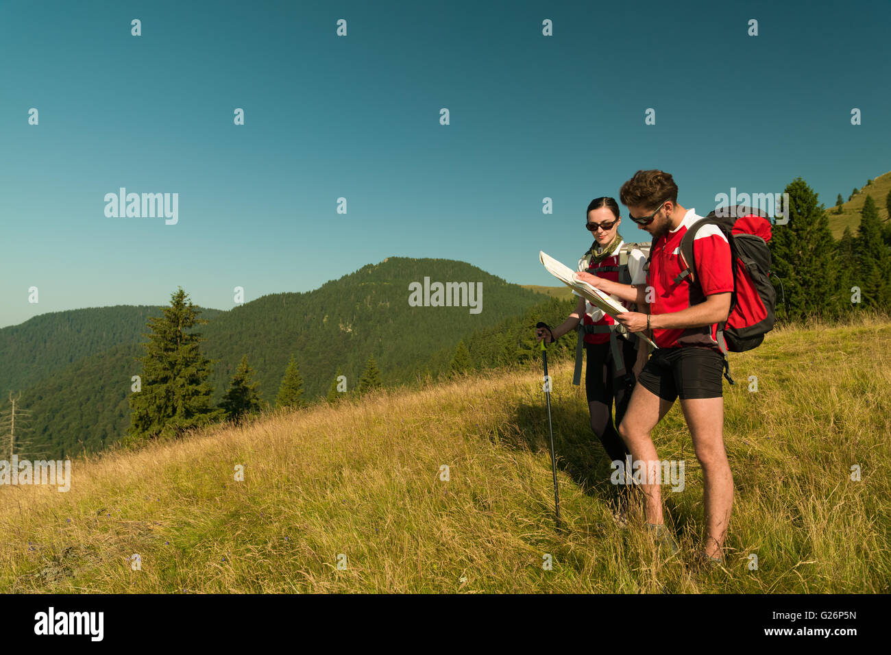 two people hiking on the mountain in a peaceful afternoon Stock Photo ...