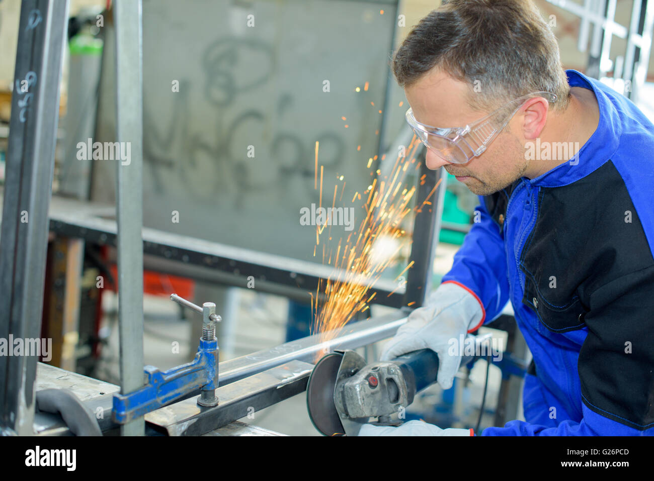 Workman using angle grinder Stock Photo - Alamy