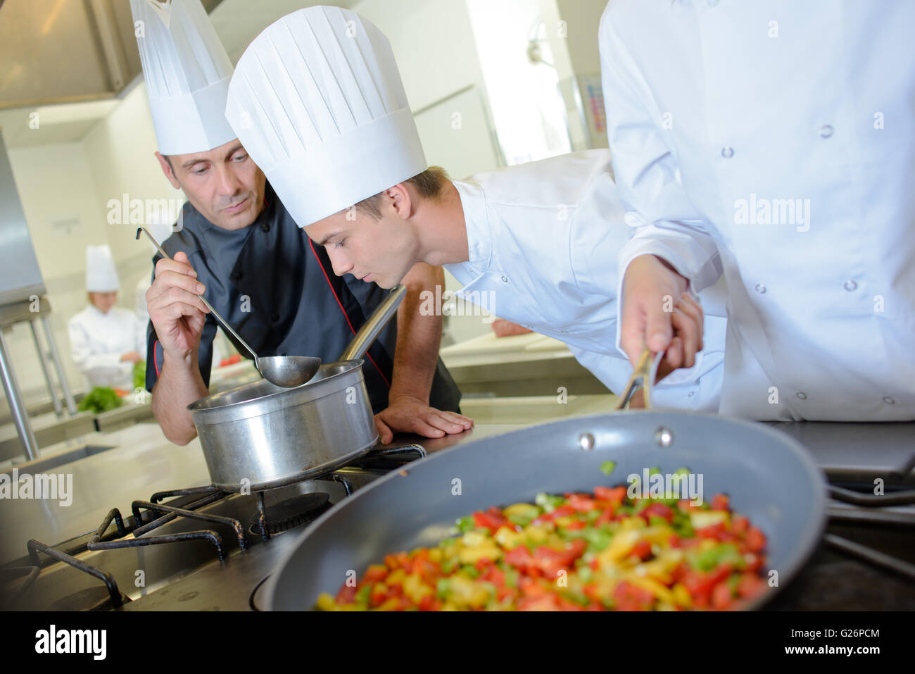 Chef smelling aroma from saucepan Stock Photo - Alamy