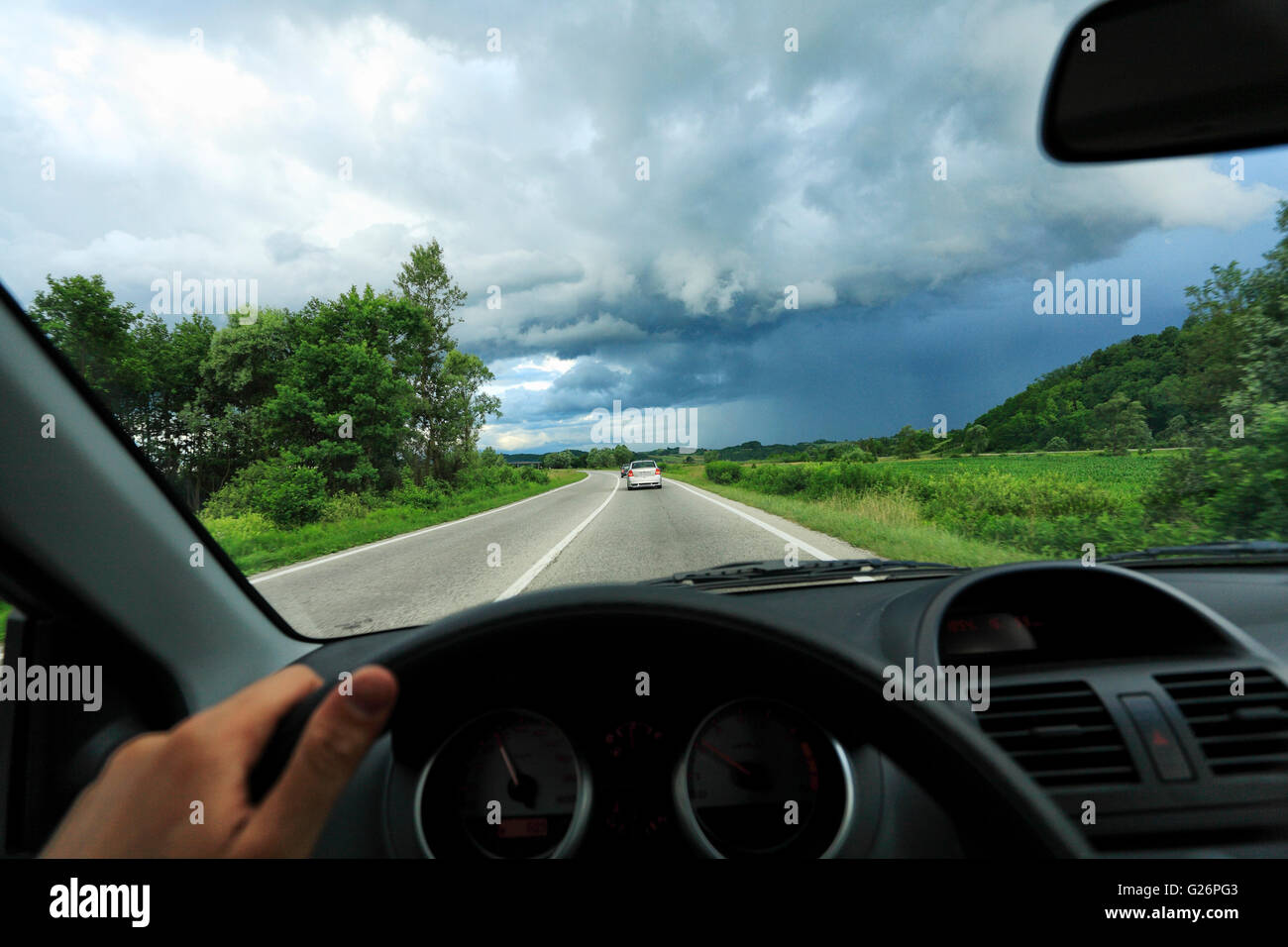 Driving a car into a rainstorm Stock Photo - Alamy