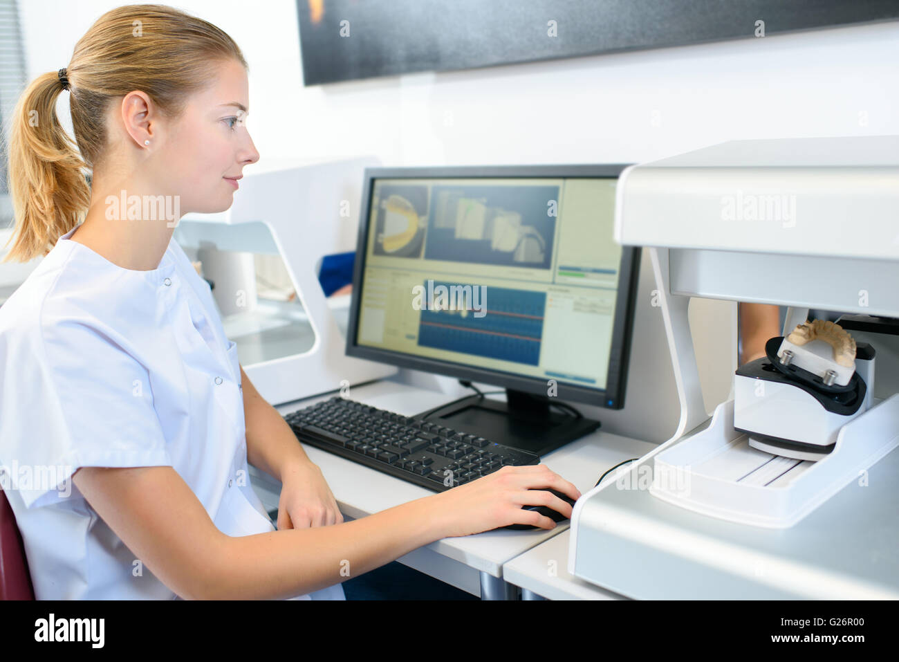 Female dentist using a computer Stock Photo - Alamy