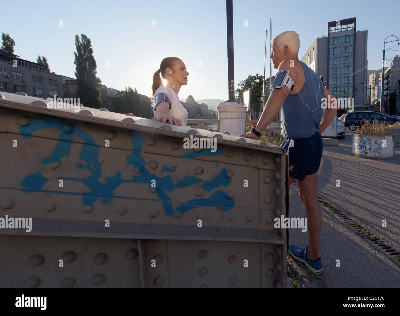 jogging couple check music playlist on phone and plan route before ...