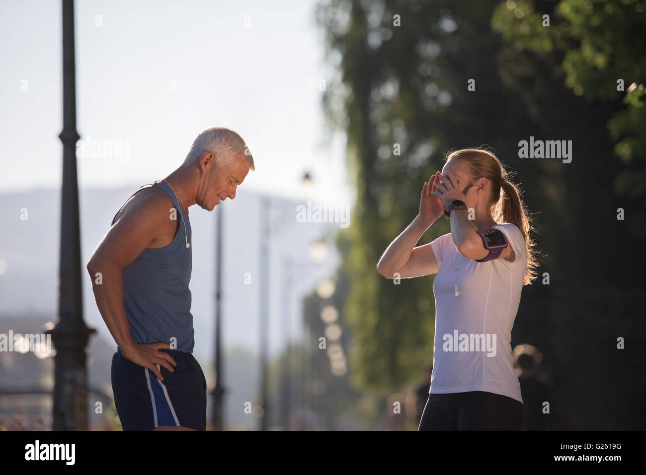 jogging couple check music playlist on phone and plan route before ...