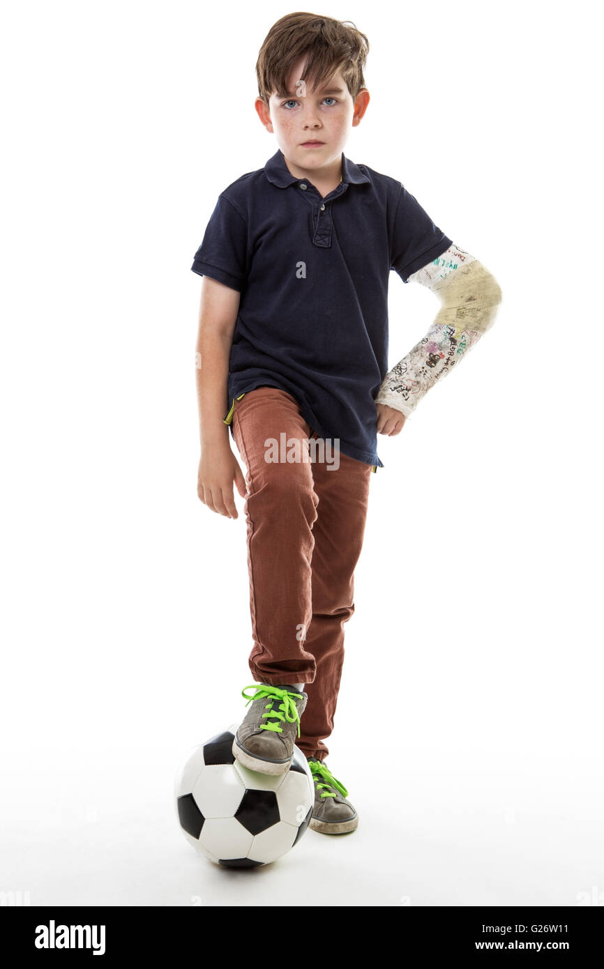 Full length shot of a young boy who cant play football with his friends ...