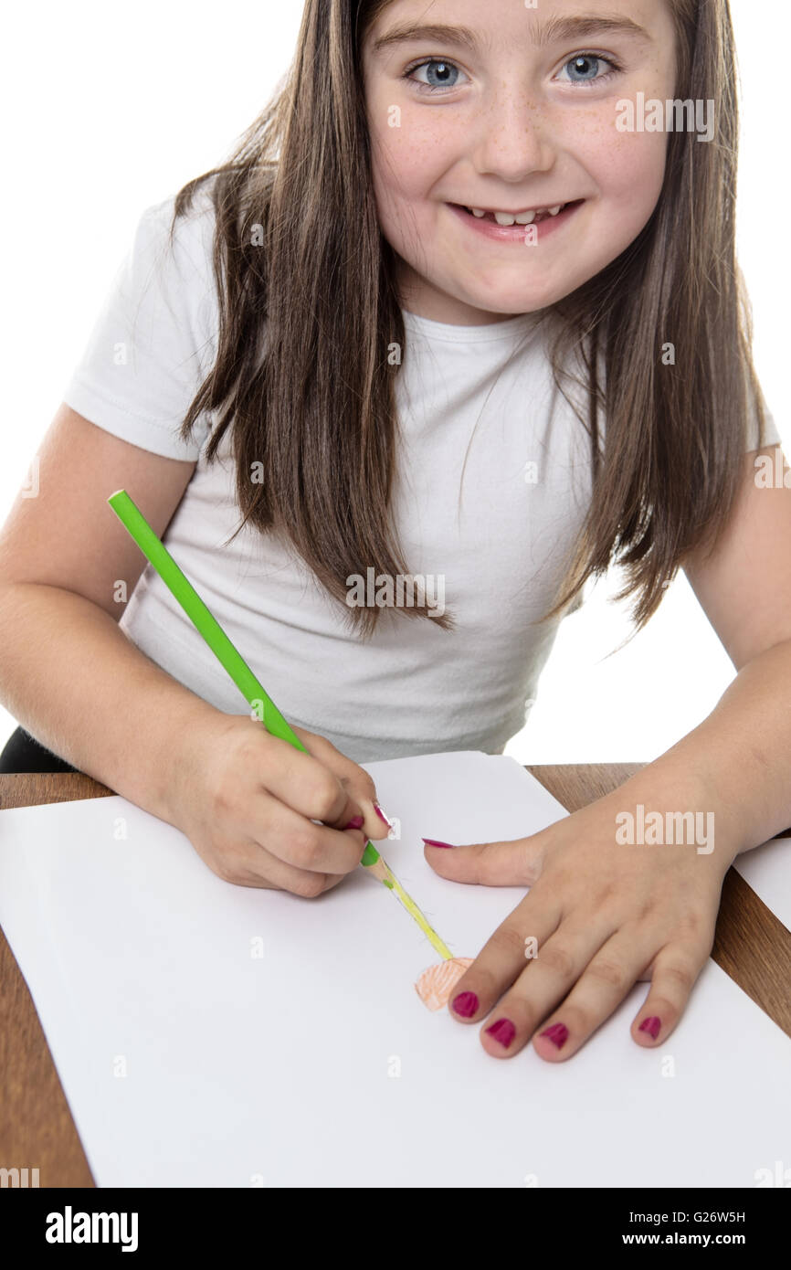 Young girl drawing a picture on paper Stock Photo - Alamy