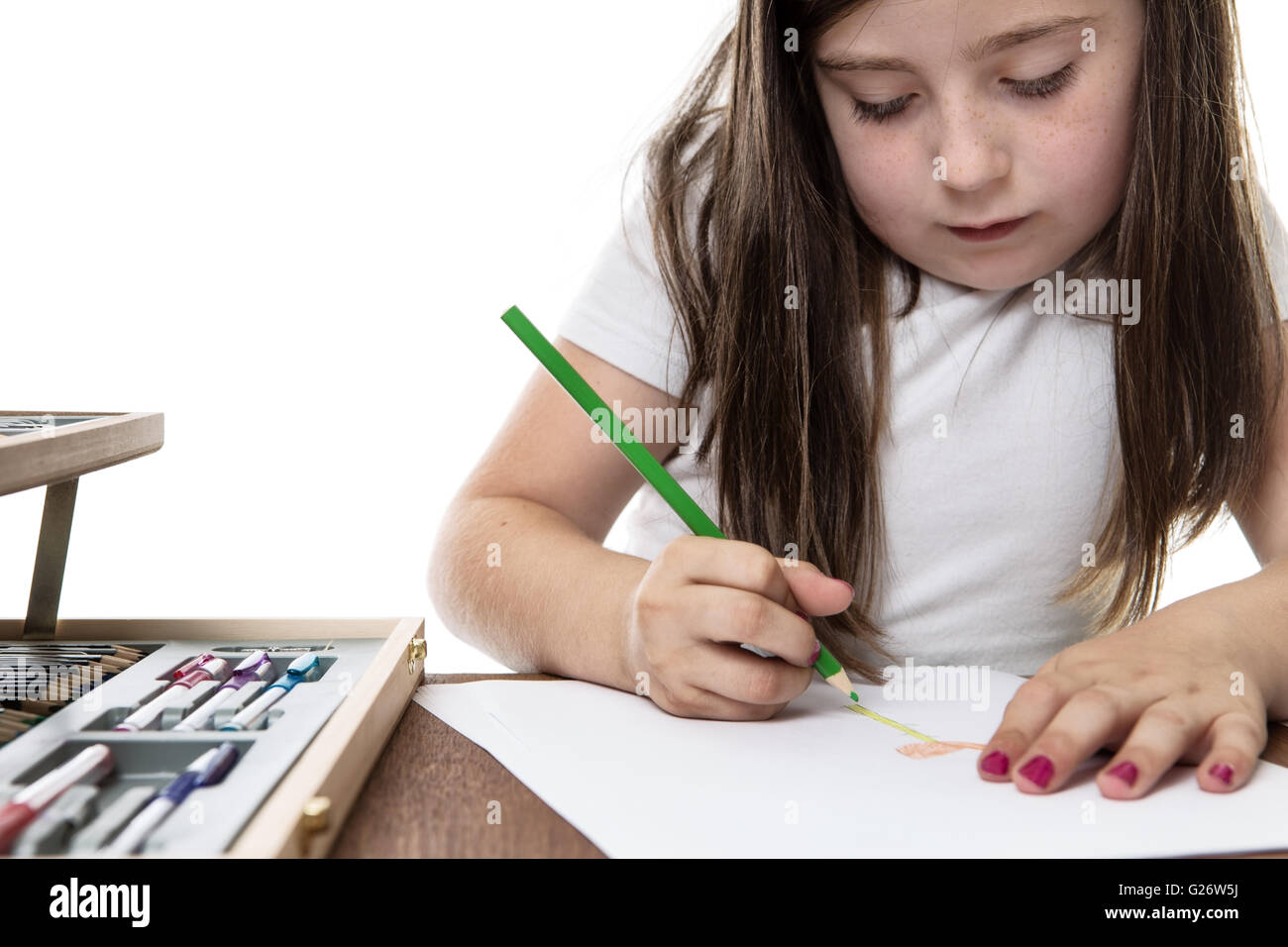 Cute young girl concentrating hard on her work Stock Photo - Alamy