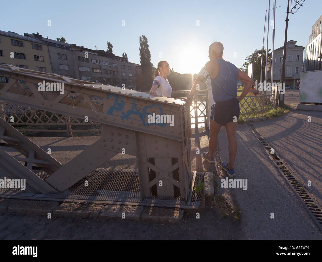 jogging couple check music playlist on phone and plan route before ...