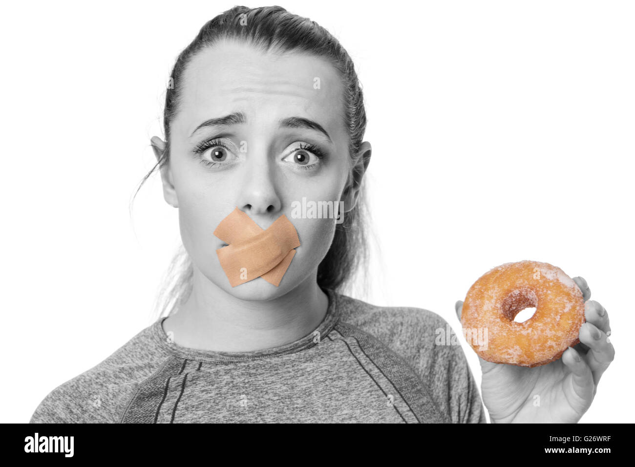woman with first aid plaster over mouth unable to eat a donut Stock ...