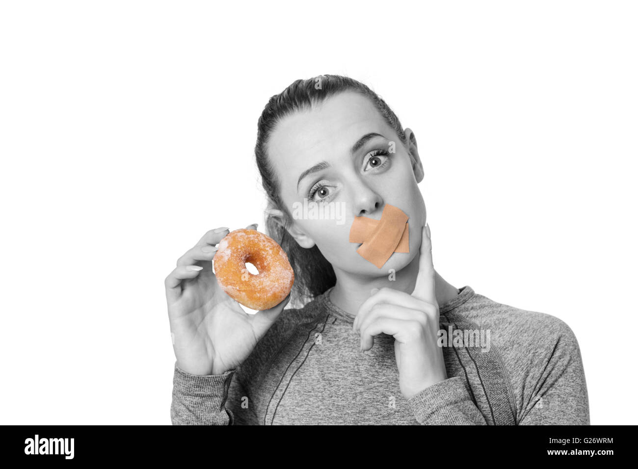 woman with first aid plaster over mouth unable to eat a donut Stock ...